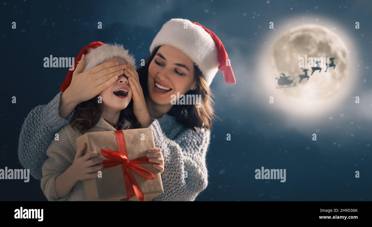 Merry Christmas and happy holidays. Cute little child with mother ...
