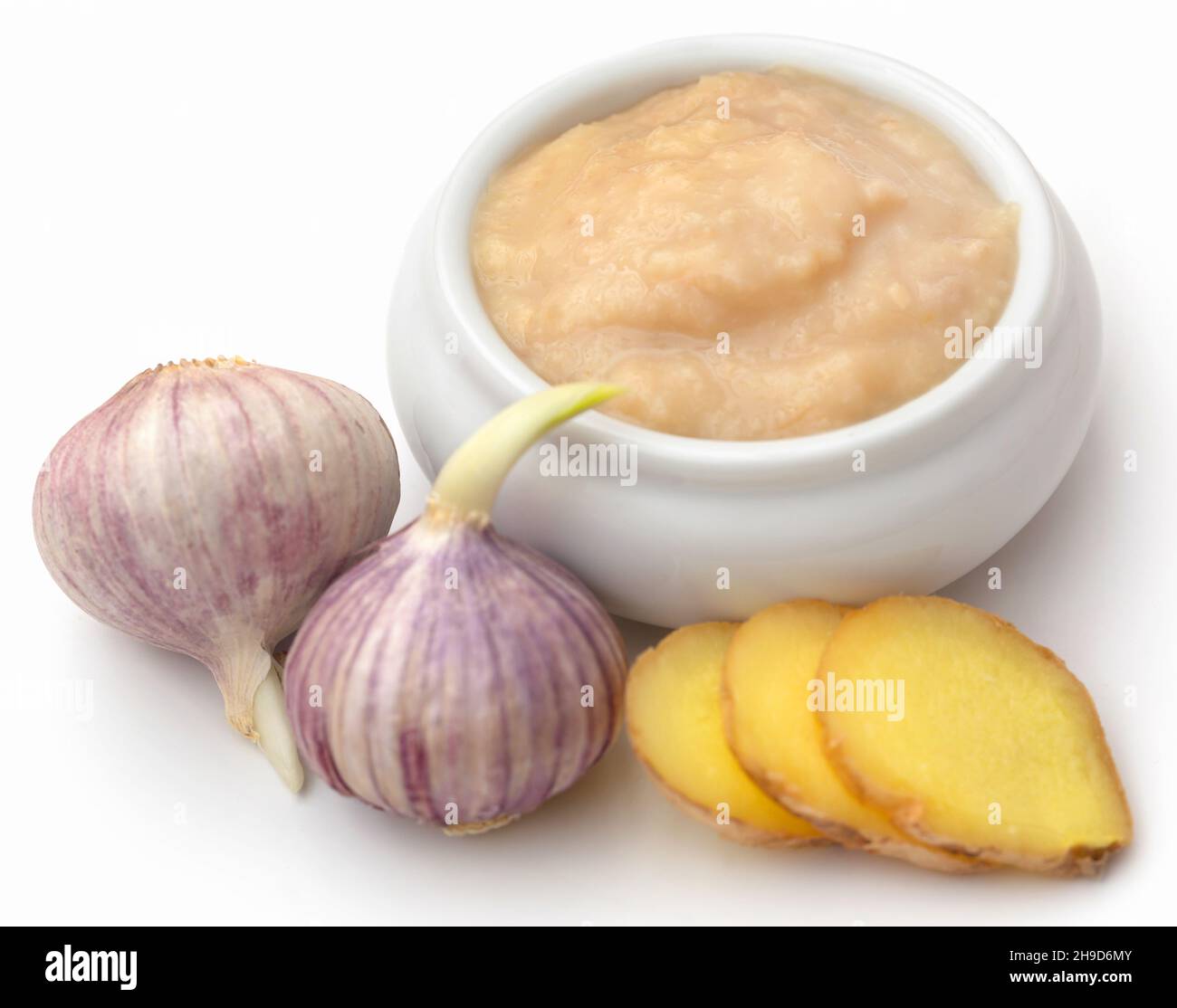 Ginger and garlic with paste over white background Stock Photo - Alamy