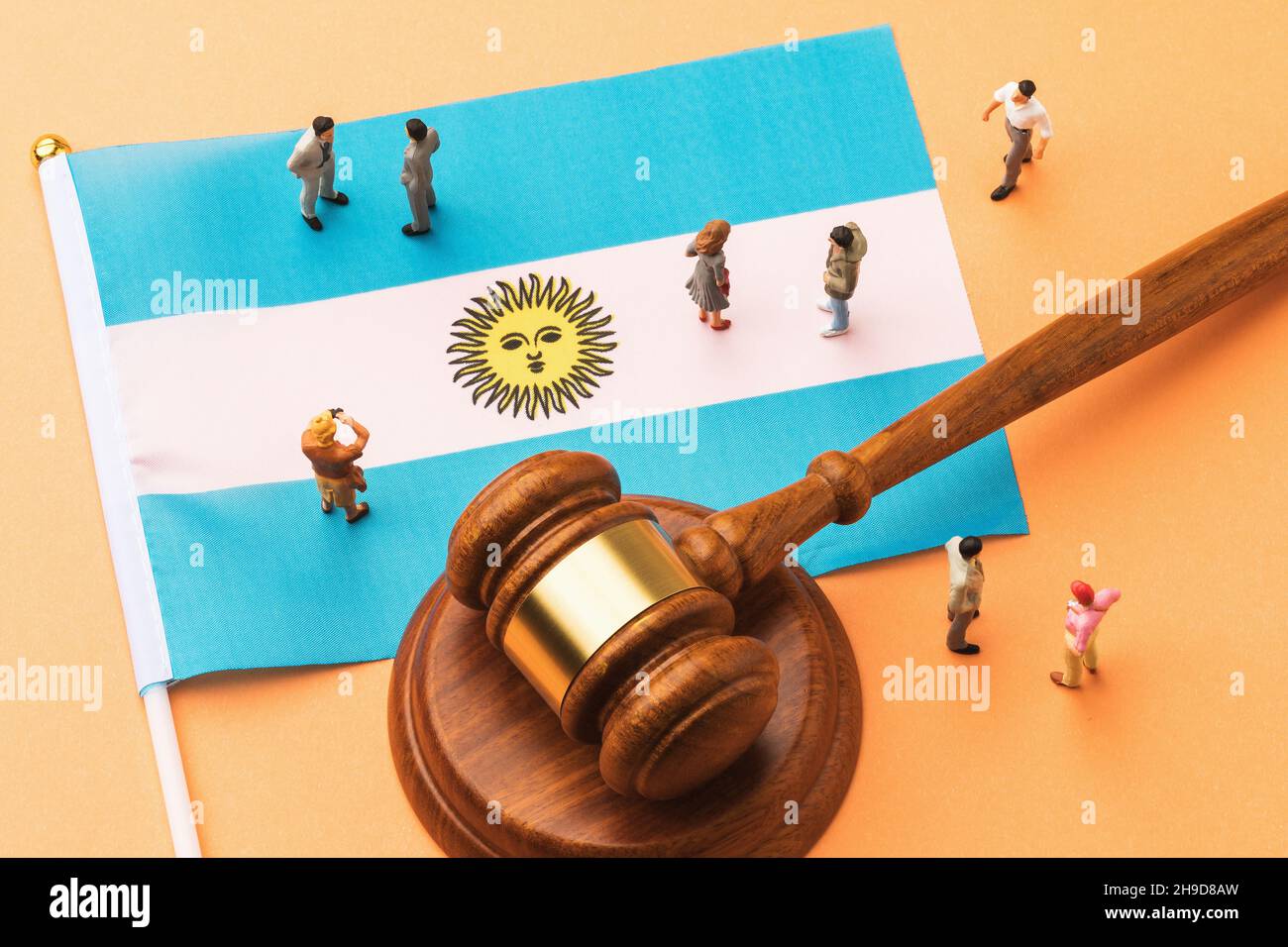 Judicial hammer, Argentine flag and plastic toy men on a colored ...