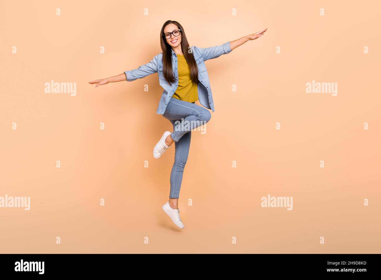 Full size photo of positive beautiful funky lady jumping spread hands ...