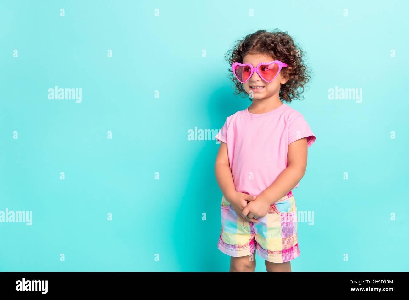 Portrait of attractive cheerful shy girl wearing big pink specs ...