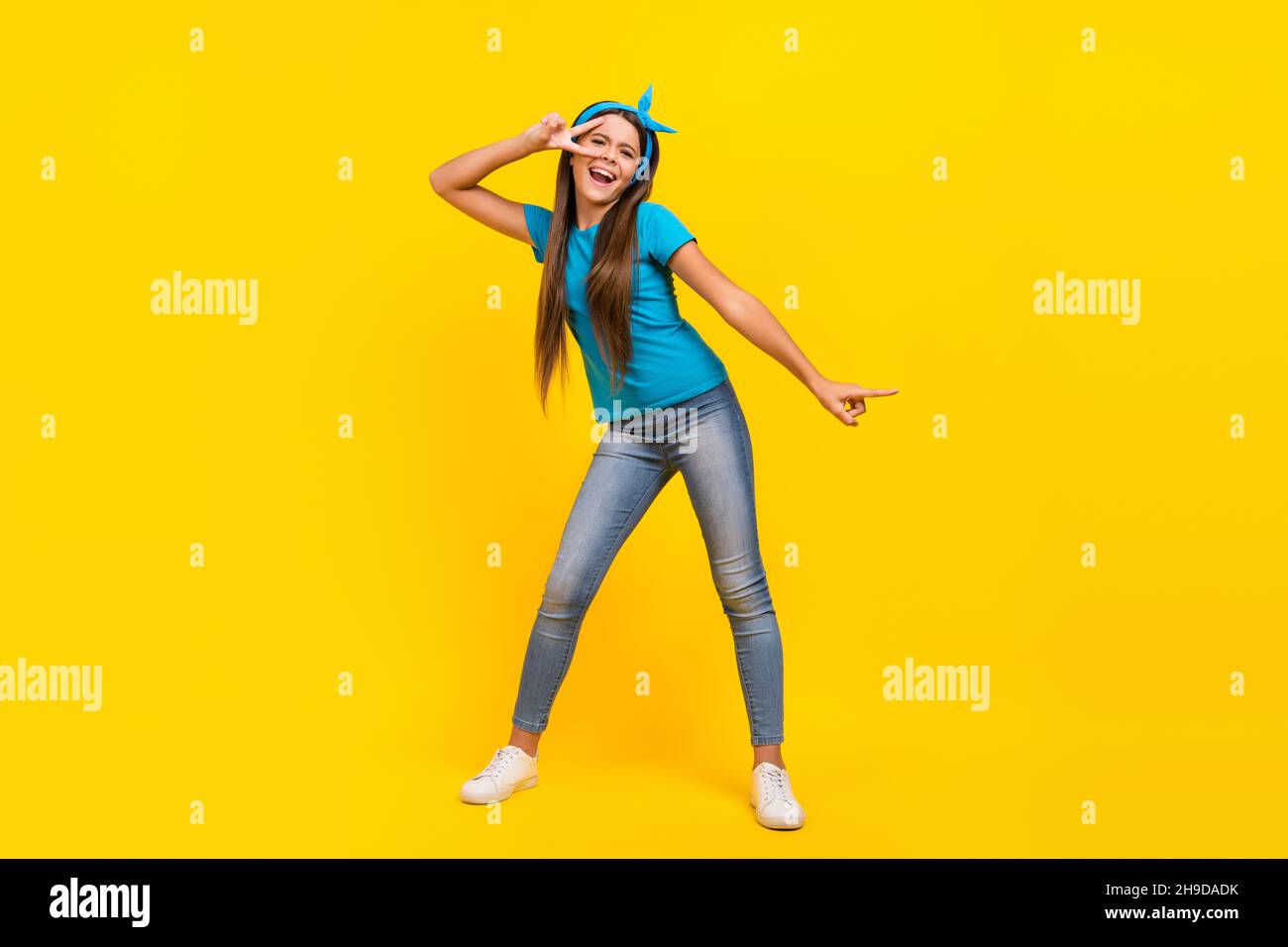 Full length photo of young excited girl good mood dancing show fingers ...