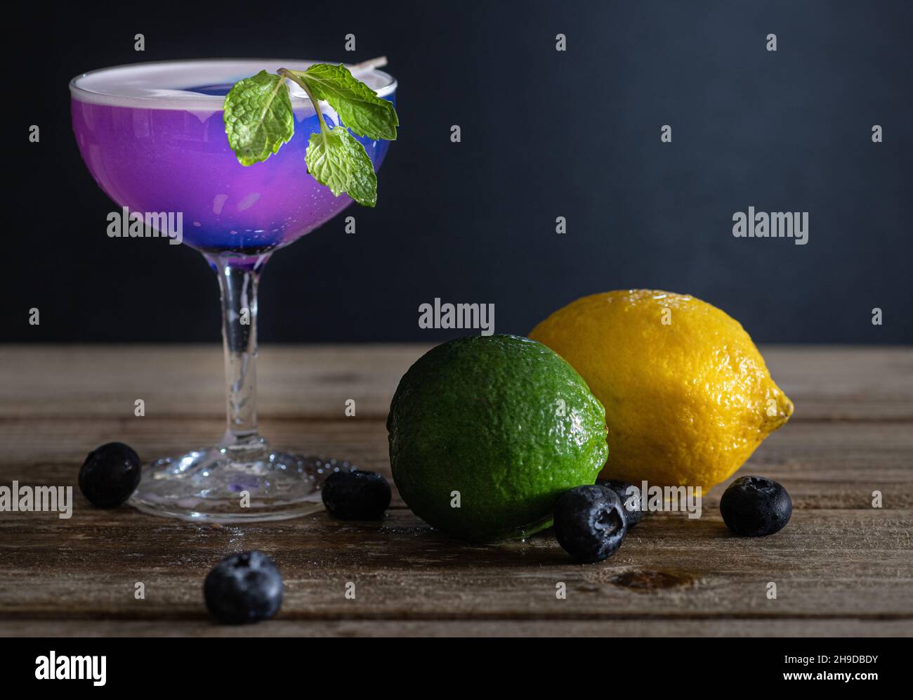 Purple Tropical Craft Cocktail with Fruit Stock Photo - Alamy