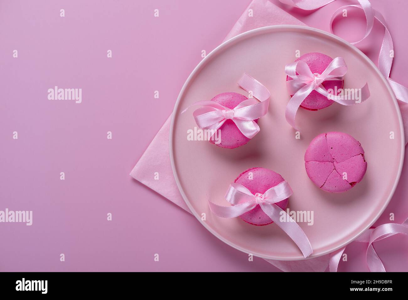 Pink macaroons on pink background. Sweet background Stock Photo - Alamy