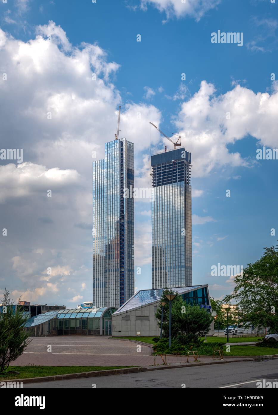 Two standing skyscrapers in a blue sky with clouds Stock Photo - Alamy