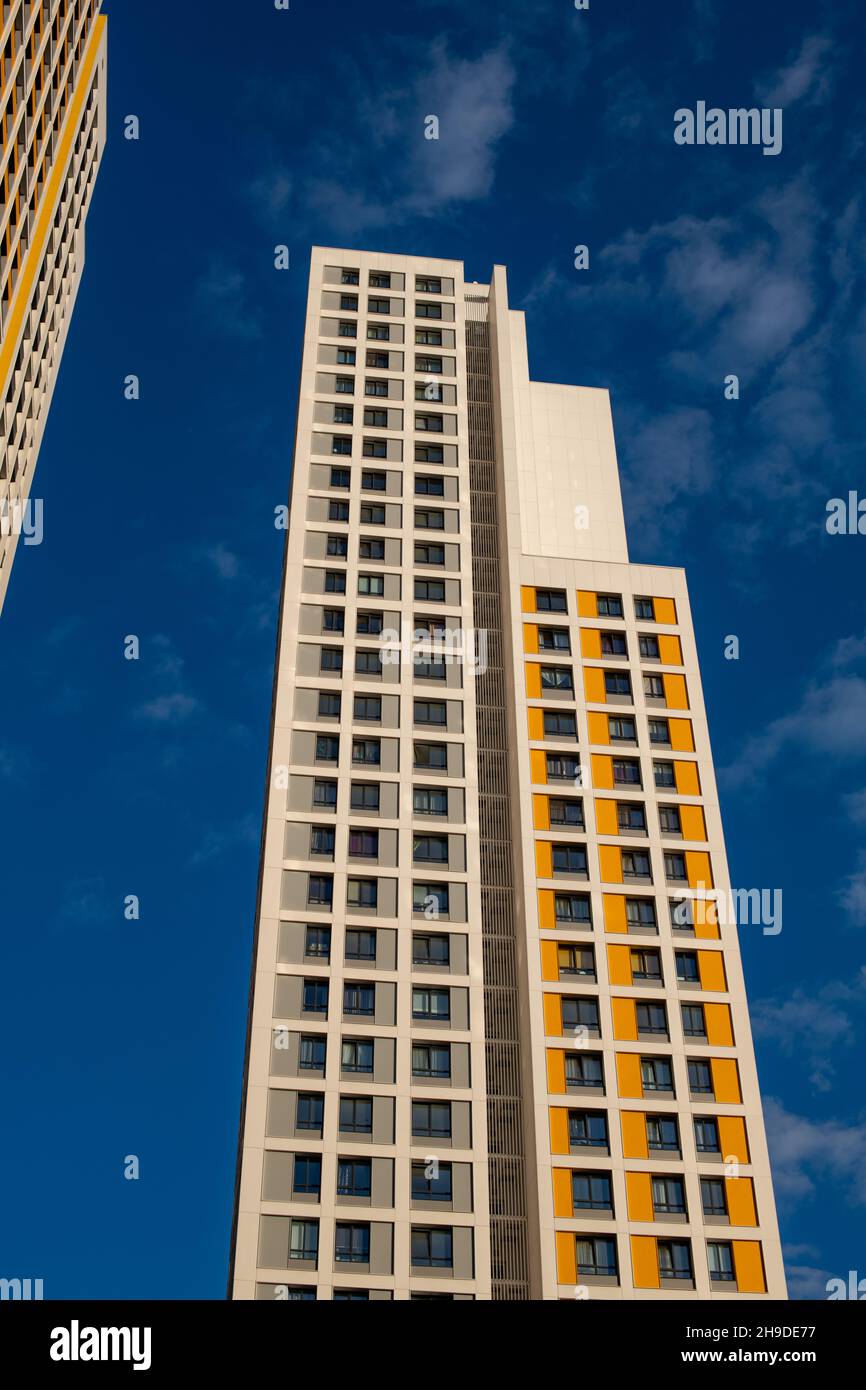 Modern building in a blue sky with clouds Stock Photo - Alamy
