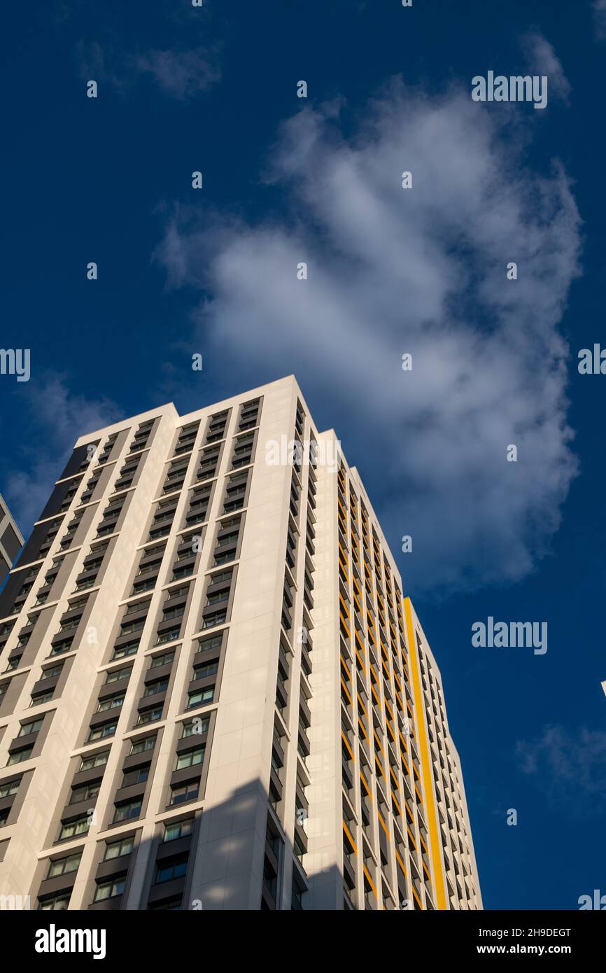 Modern building in a blue sky with clouds Stock Photo - Alamy