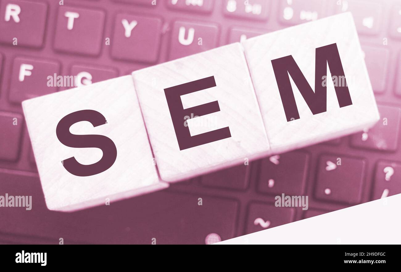SEM Search Engine Marketing written on a wooden cubes put on computer ...