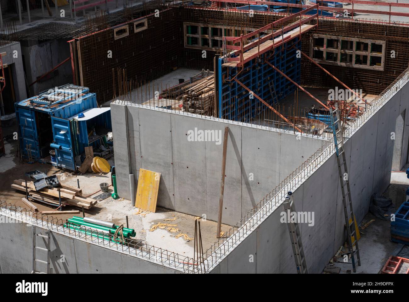 an unfinished building with concrete walls with metal ladders and ...