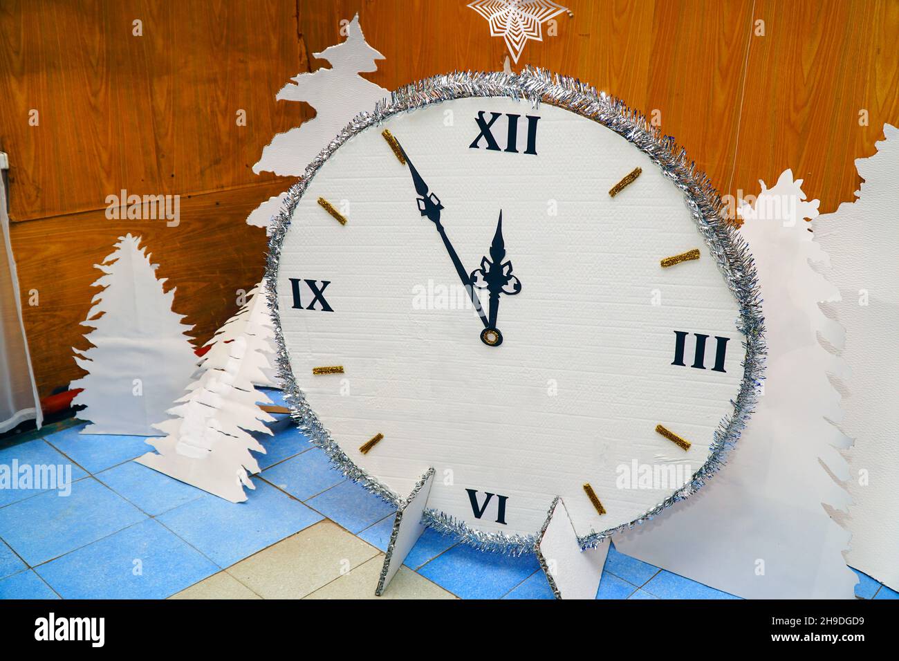 Homemade Christmas clock made of paper or cardboard. It's five minutes ...