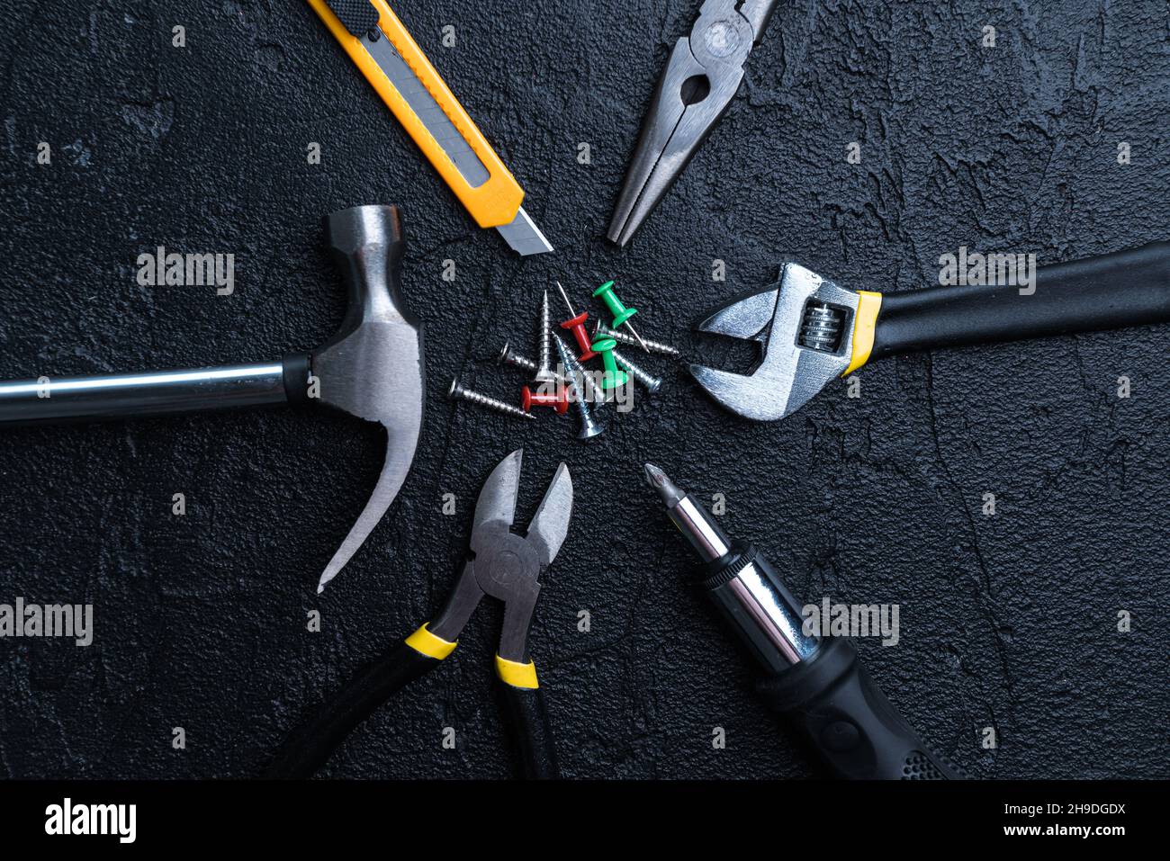 Tools for master builder on a black background Stock Photo - Alamy