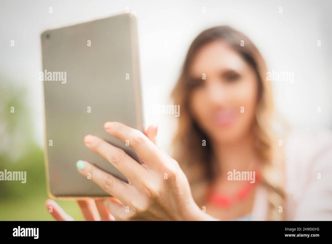 Attractive young model fashion woman taking selfies with tablet ...