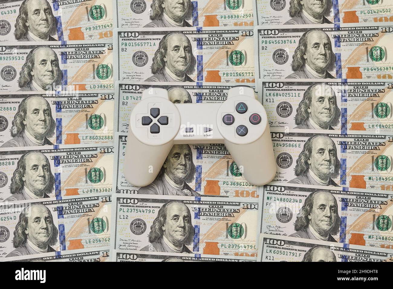 Game console controller and pile of money. Gamepad and us dollars ...