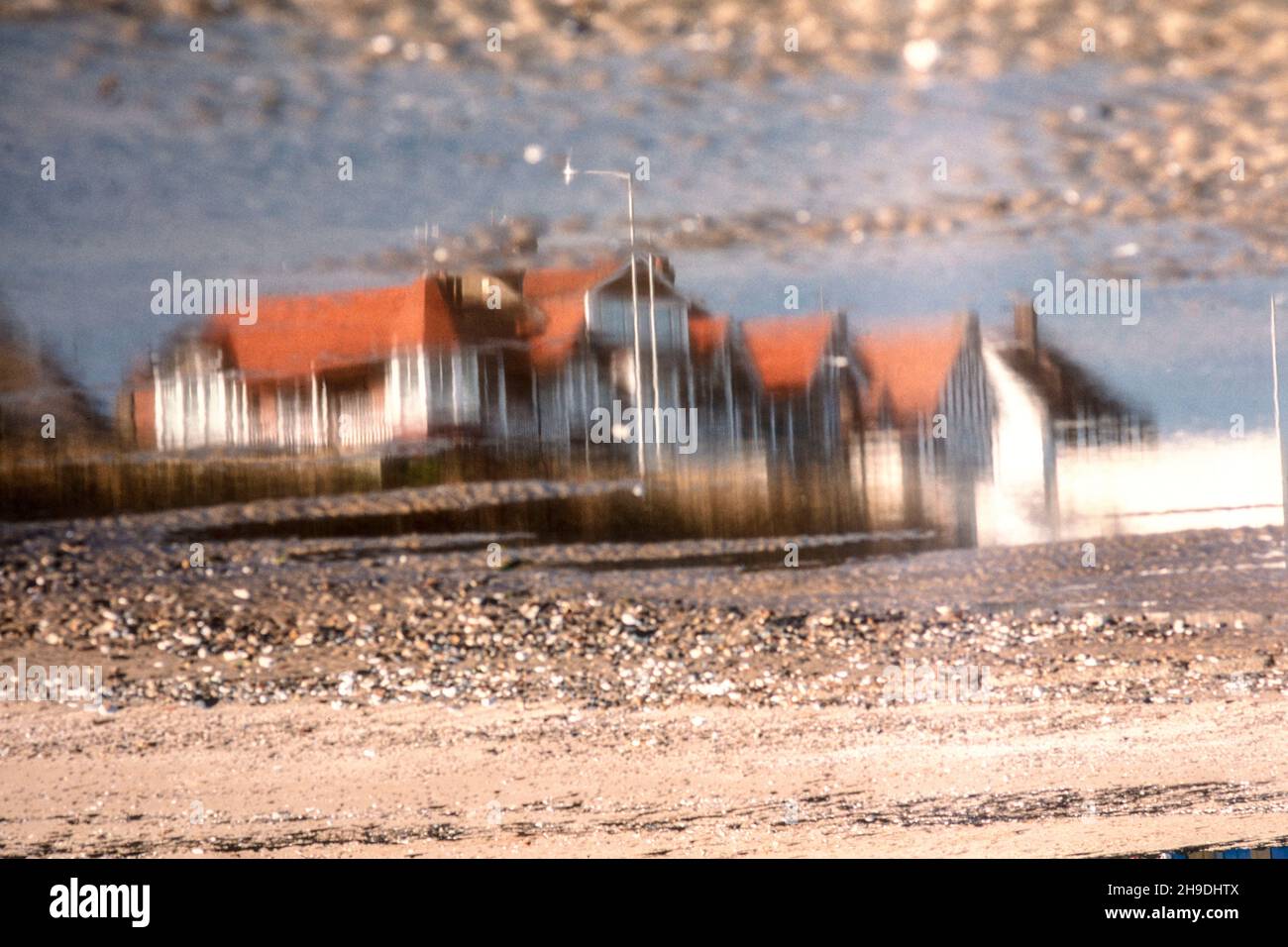 Intimate landscape of Reflection along sandy beach with rippling sand ...