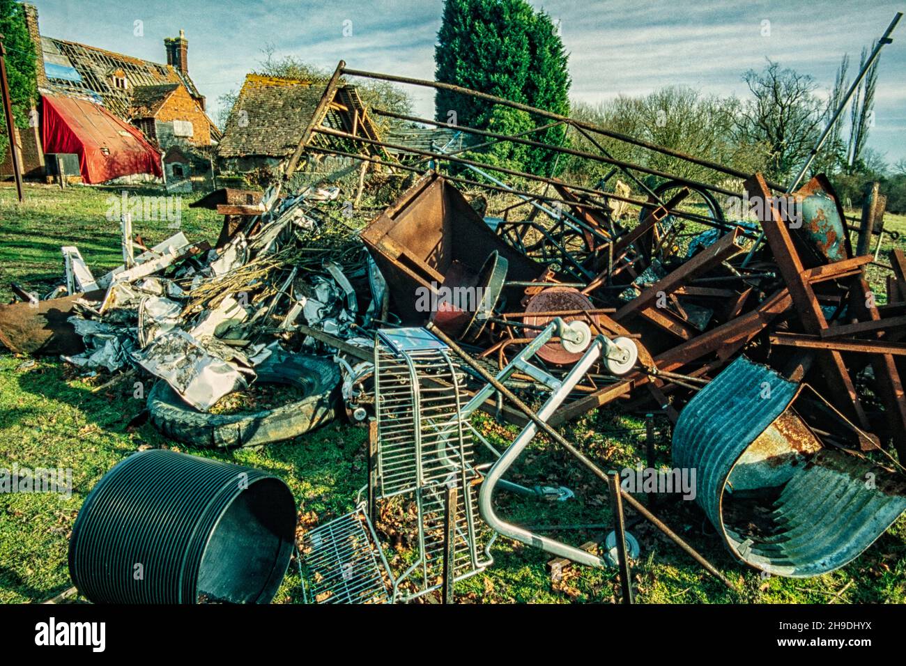 Discarded waste material in the environment under a sunny blue sky ...
