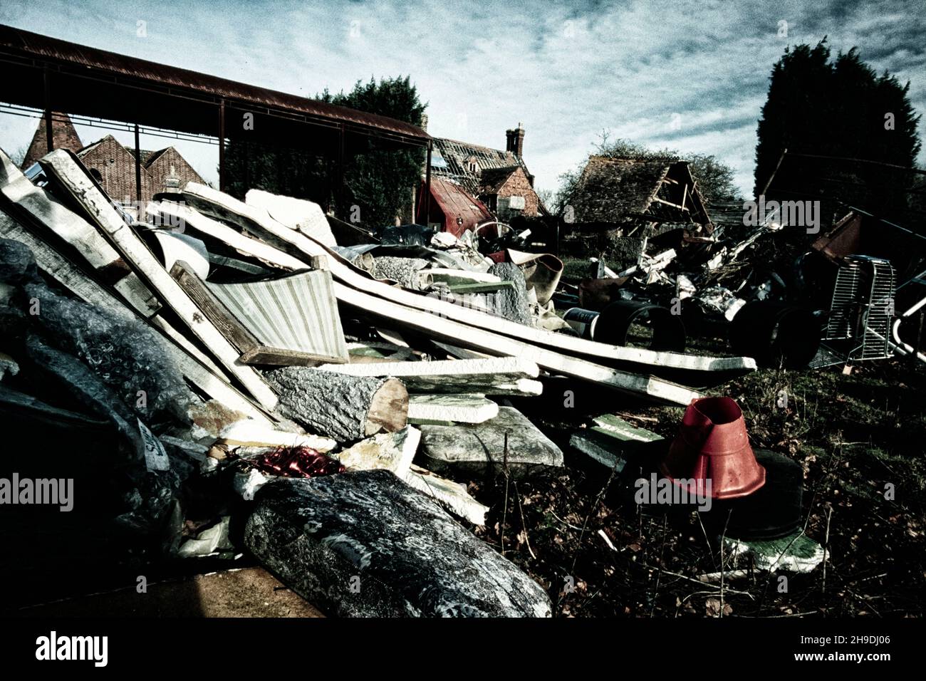 Discarded waste material in the environment under a sunny blue sky ...