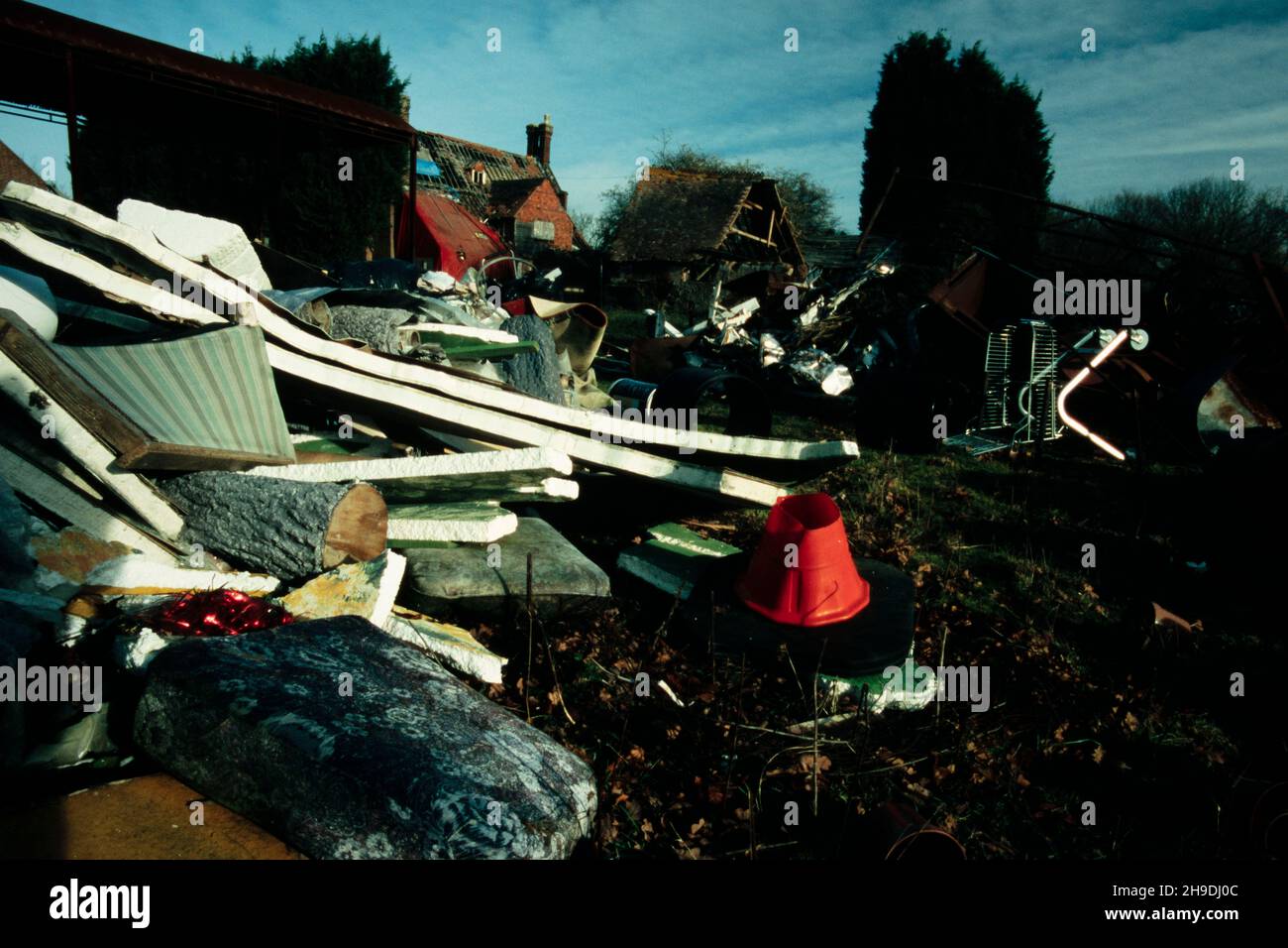 Discarded waste material in the environment under a sunny blue sky ...