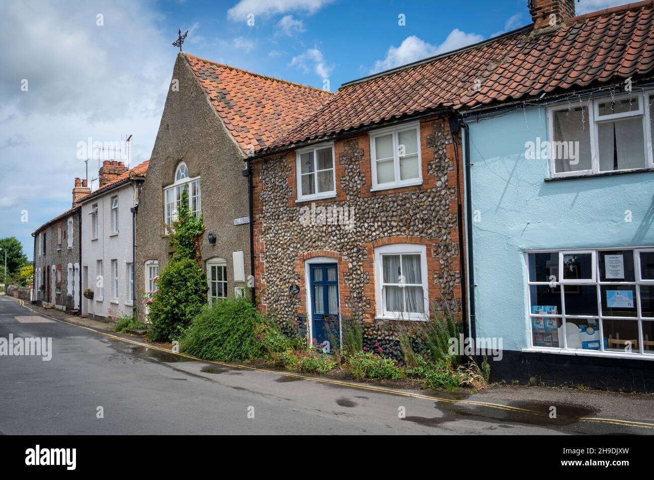 A row of old houses in Holt Norfolk UK including some with flint walls ...
