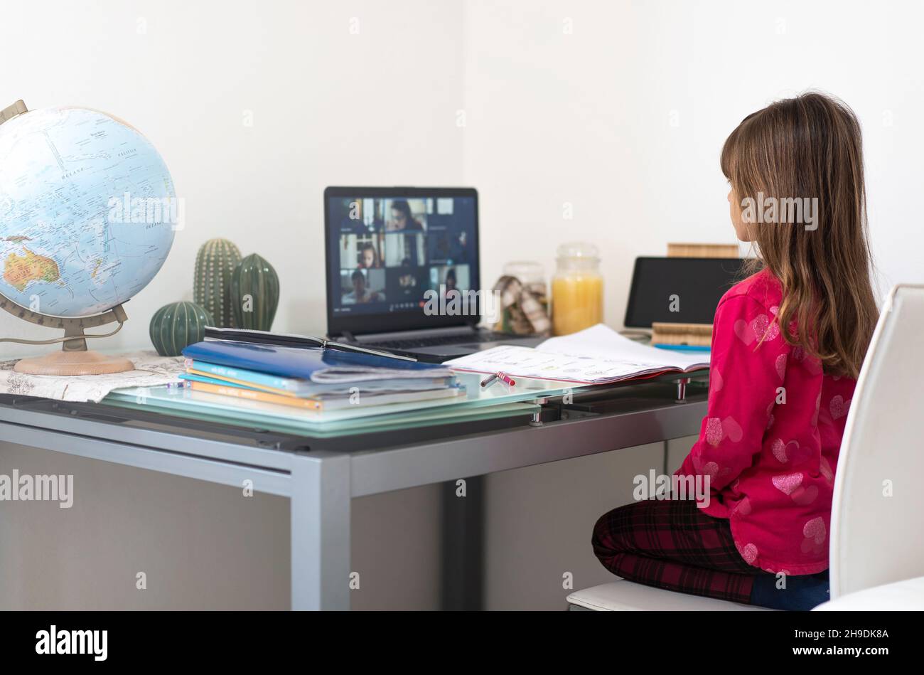 Elementary schooler child girl at home with laptop for remote ...