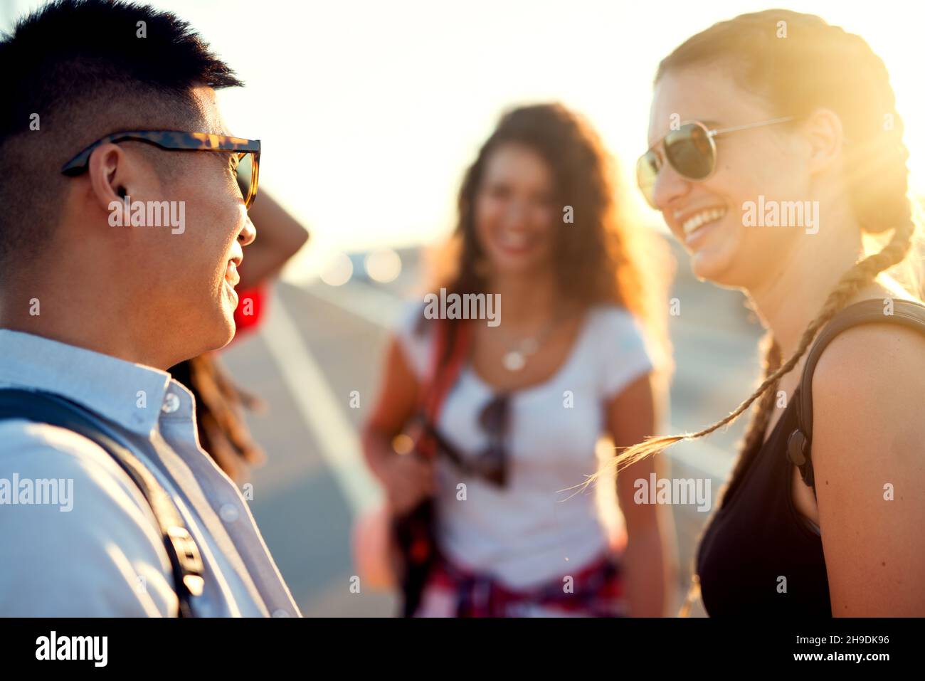 Group of charming friends with sunglasses and backpacks Stock Photo - Alamy