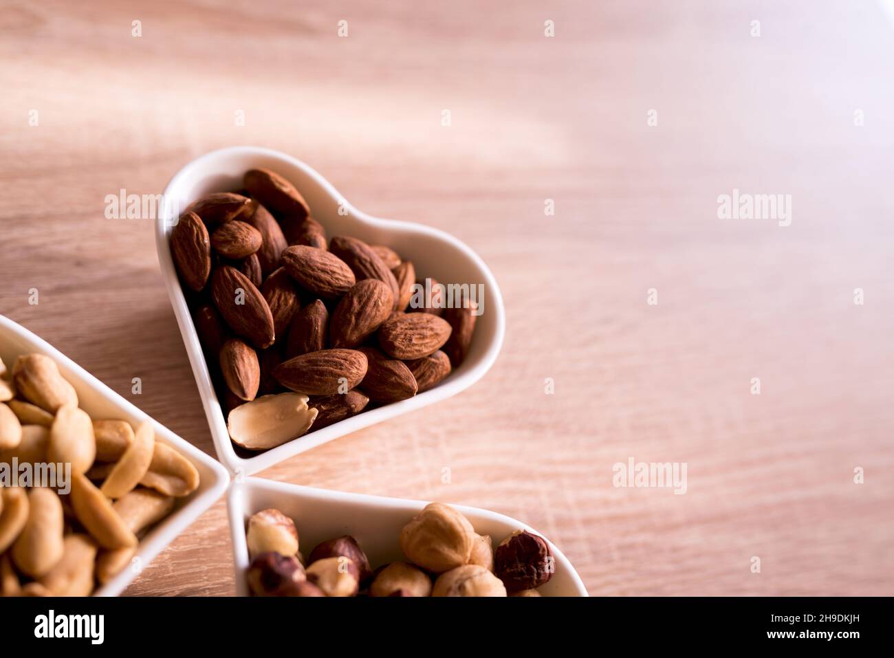 Cropped picture of different kinds of healthy nuts in small serving ...
