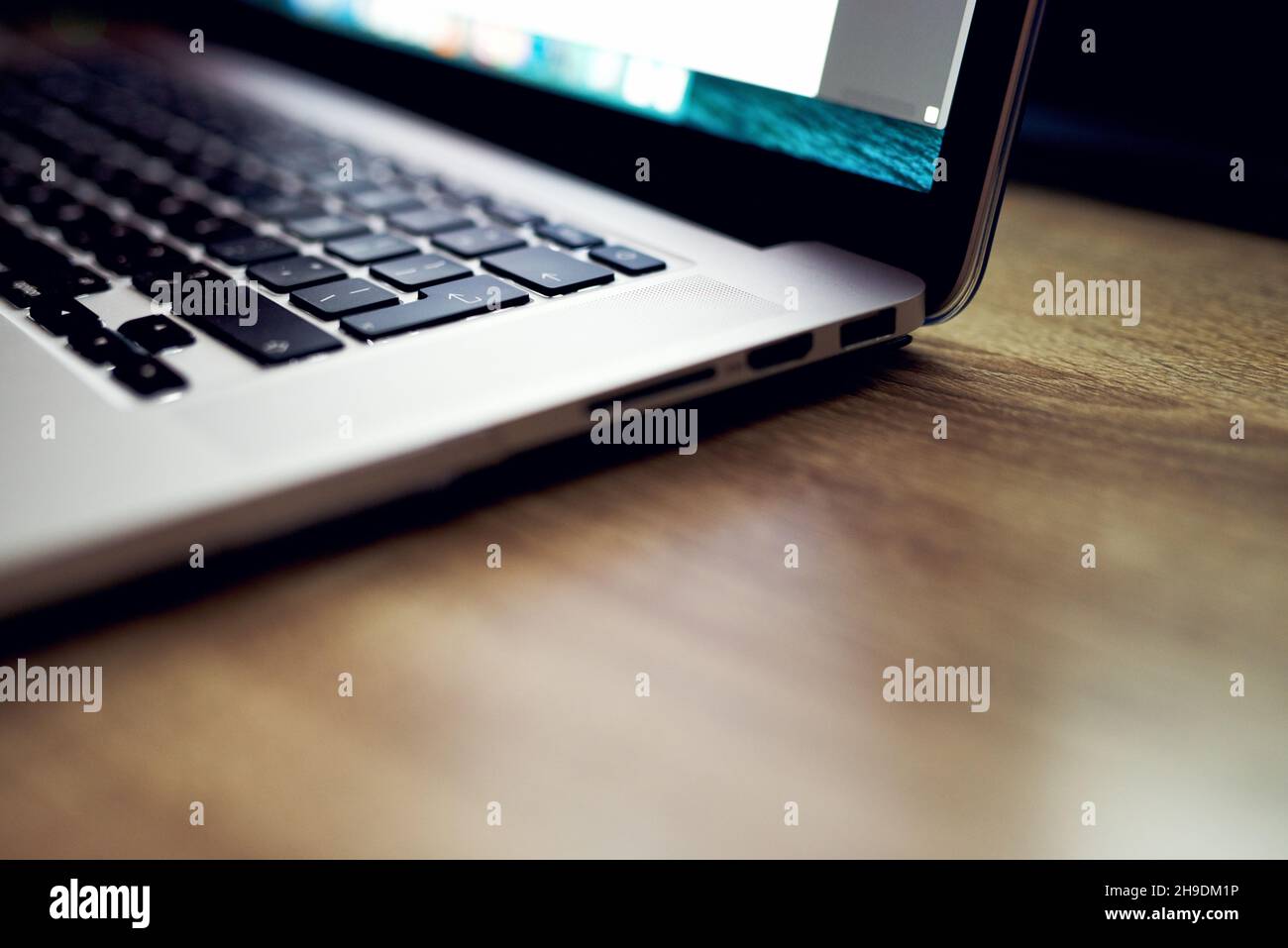 Side view of modern wood office table with working laptop. Modern ...