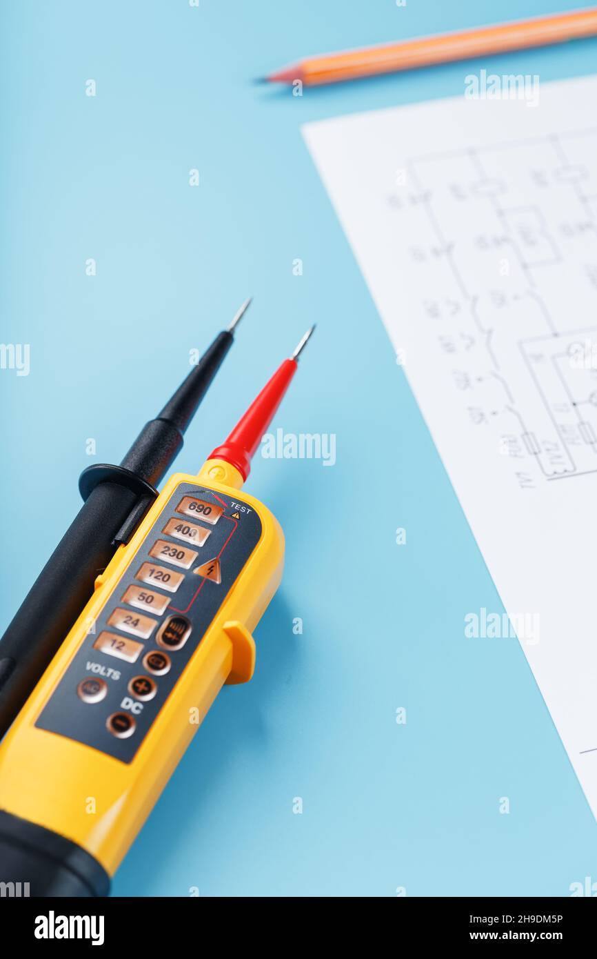 Yellow voltage indicator with an electrical diagram on a blue ...