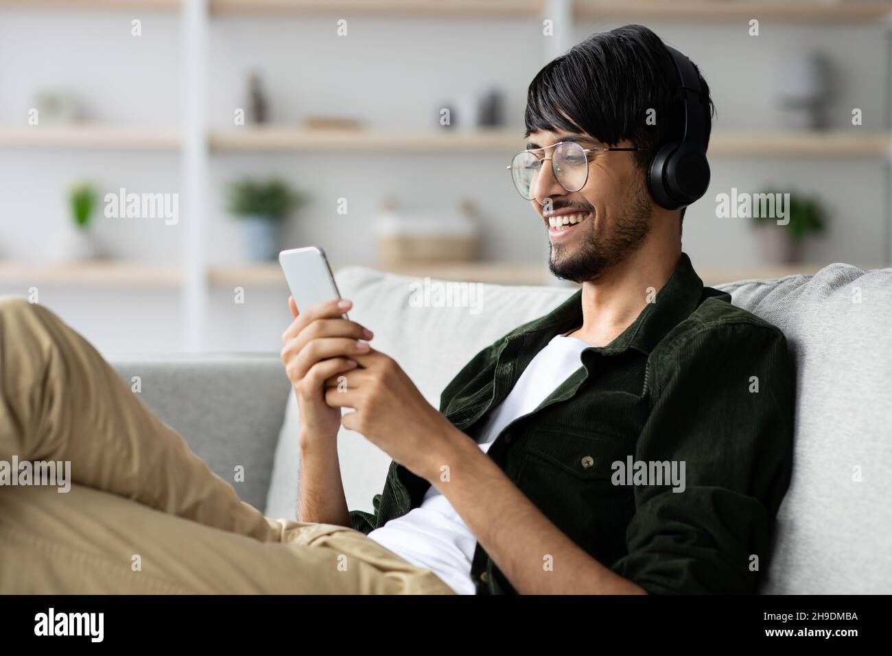 Handsome indian guy watching video on smartphone Stock Photo - Alamy