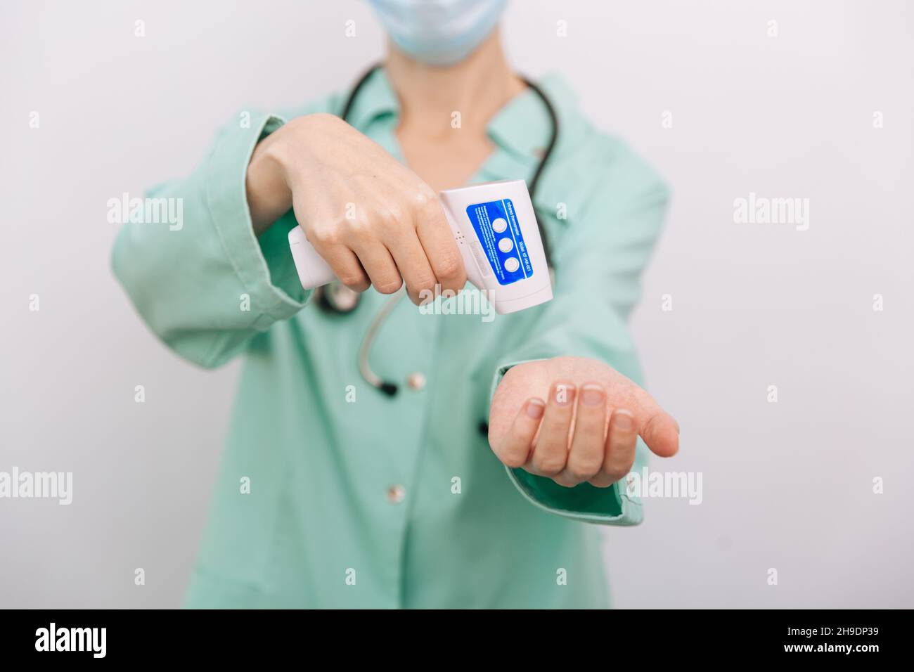 Temperature measurement gun in doctor hands. Close-up shot of doctor ...