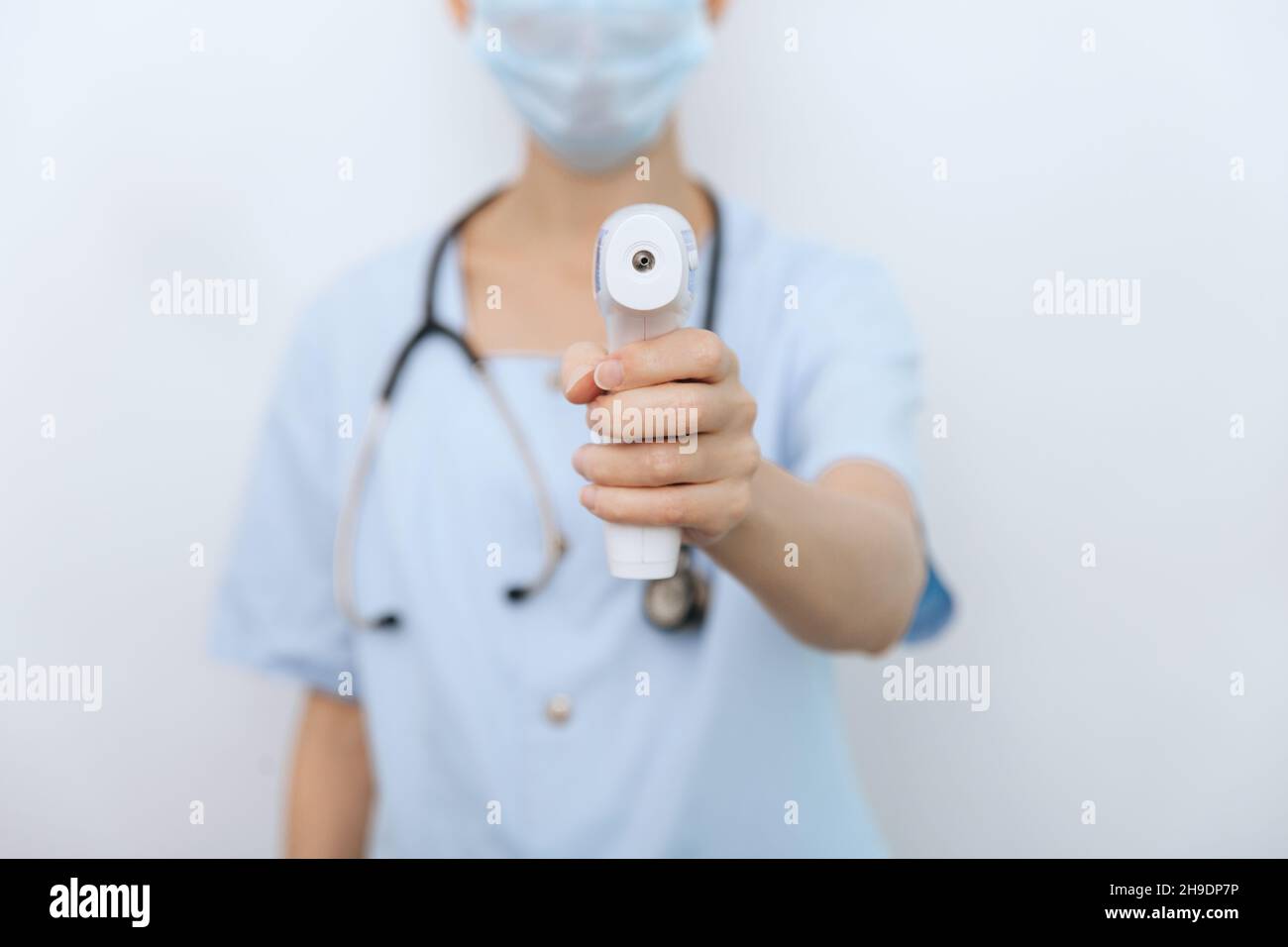 Temperature measurement gun in doctor hands. Close-up shot of doctor ...