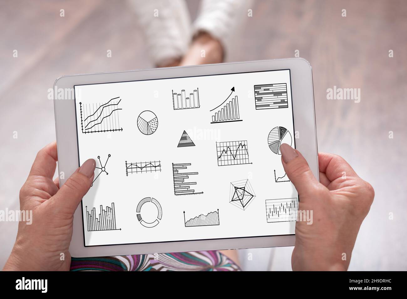 Graphical analysis concept shown on a tablet held by a woman Stock ...