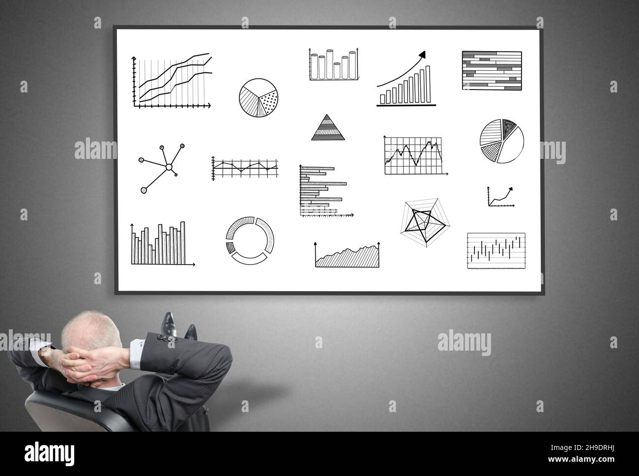 Relaxed businessman looking at graphical analysis concept on a ...