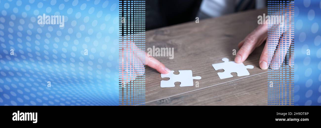 Hands joining two puzzle pieces, teamwork concept. panoramic banner ...