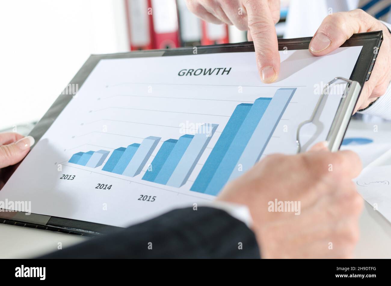 Finger pointing on a graph showing growth Stock Photo - Alamy