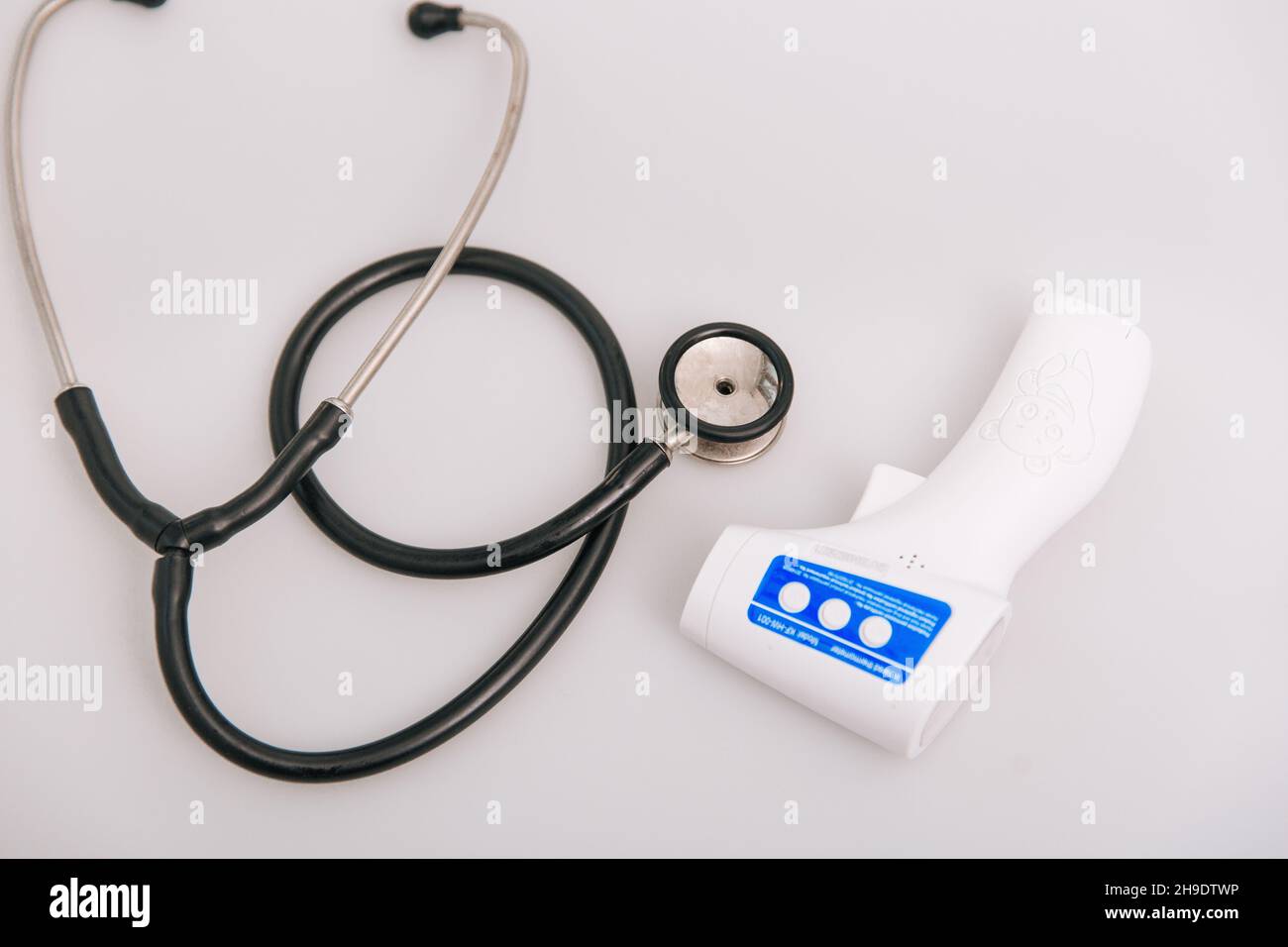 Stethoscope, pulse oximeter and thermometer gun on white background ...