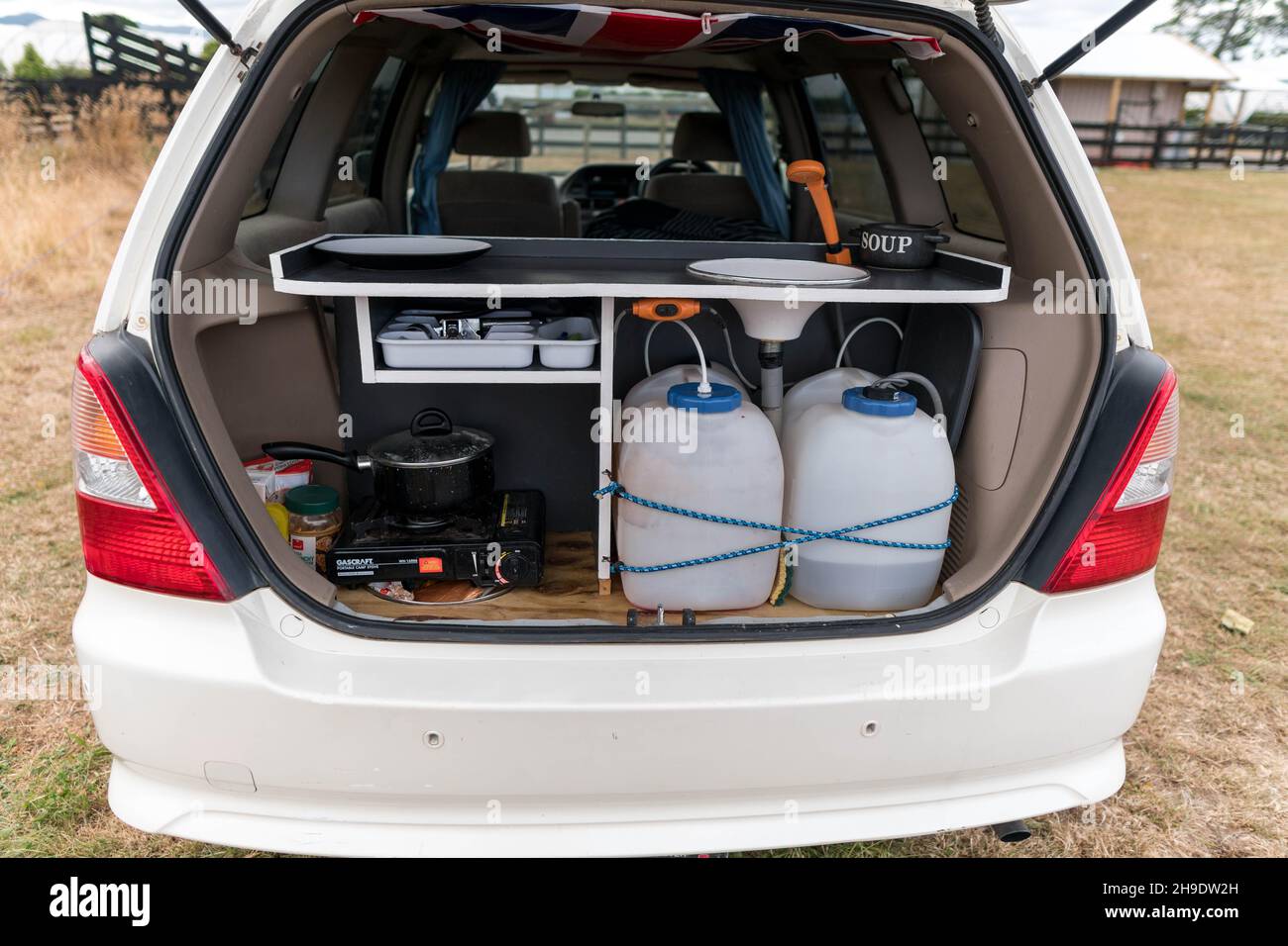 A camper van with its trunk open on a road, Concept of travelling ...