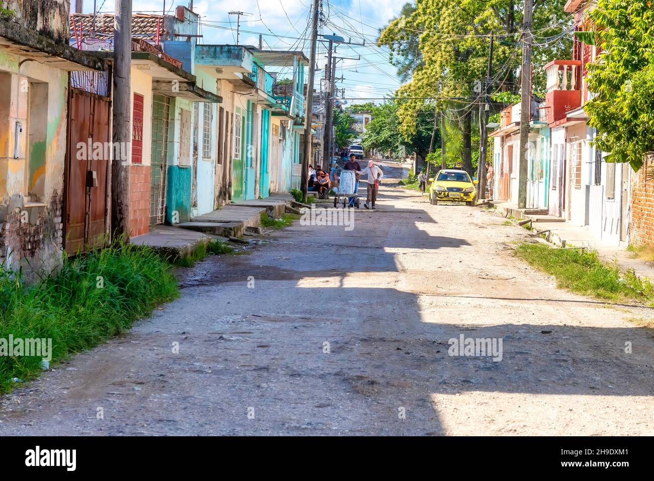 A run down Cuban city street with houses to both sides.Dec. 6, 2021 ...