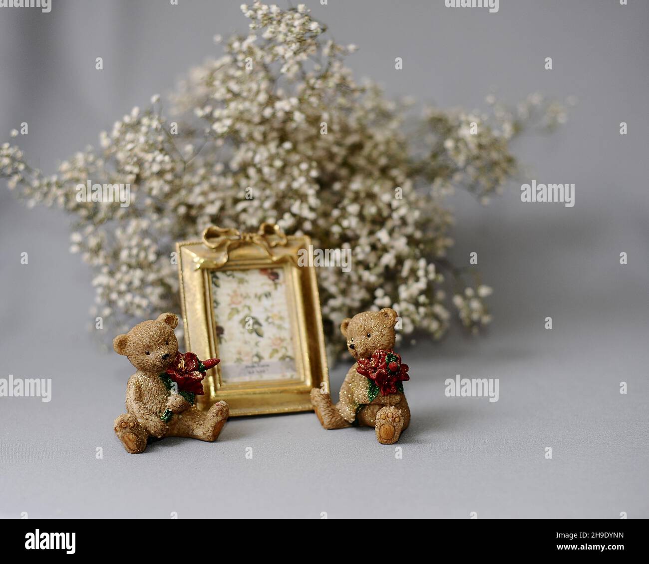 Valentines day gift idea. Golden photo frame and figurines of teddy ...