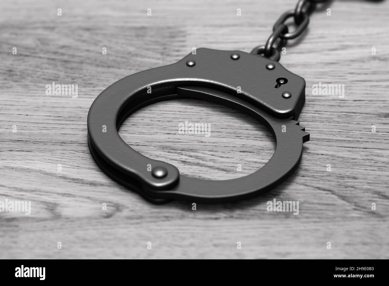 Black locked police handcuffs hi-res stock photography and images - Alamy