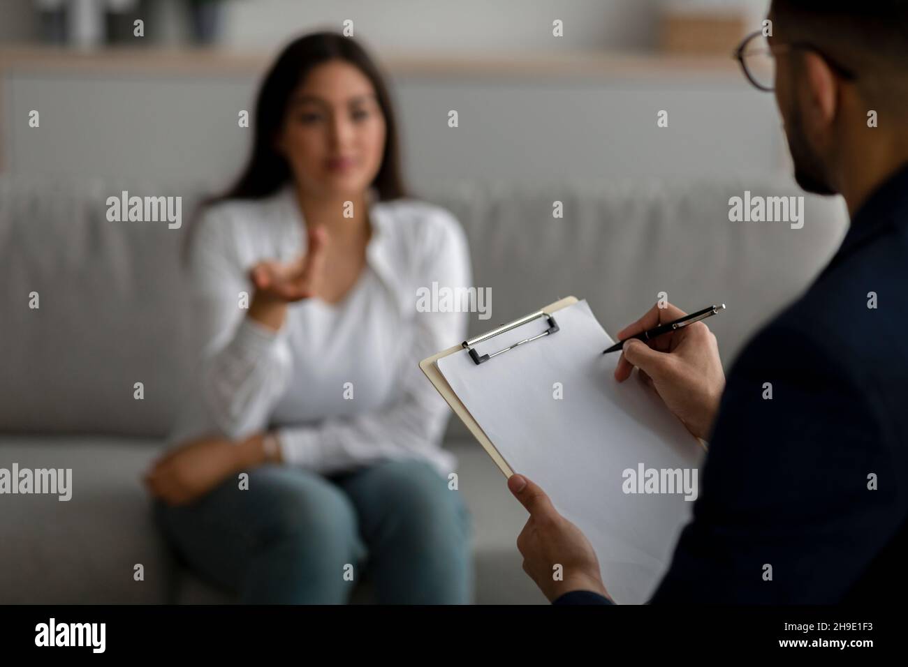 Stressed arab woman consulting psychologist at medical office ...