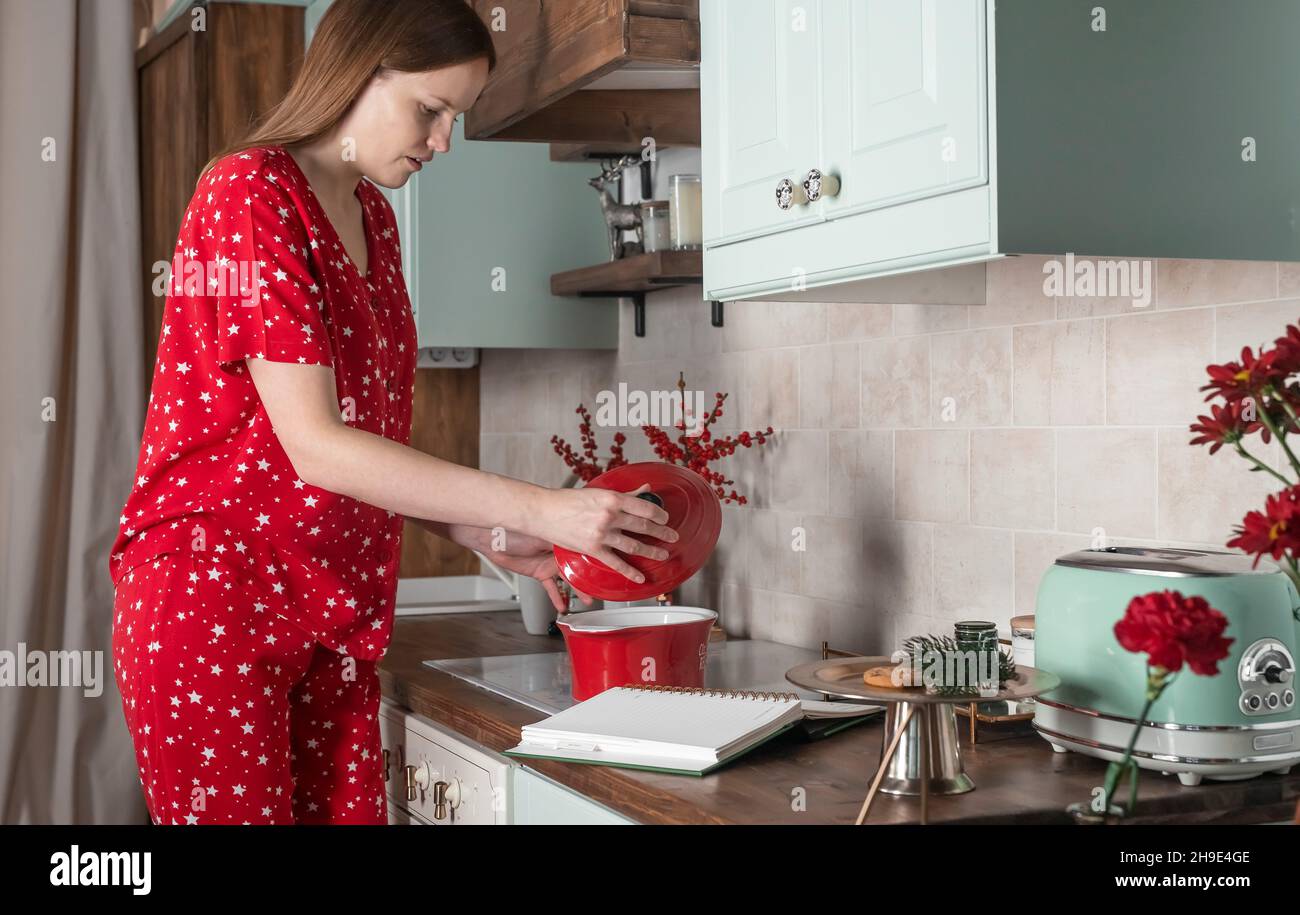 Woman cooking reading recipe hi-res stock photography and images - Alamy
