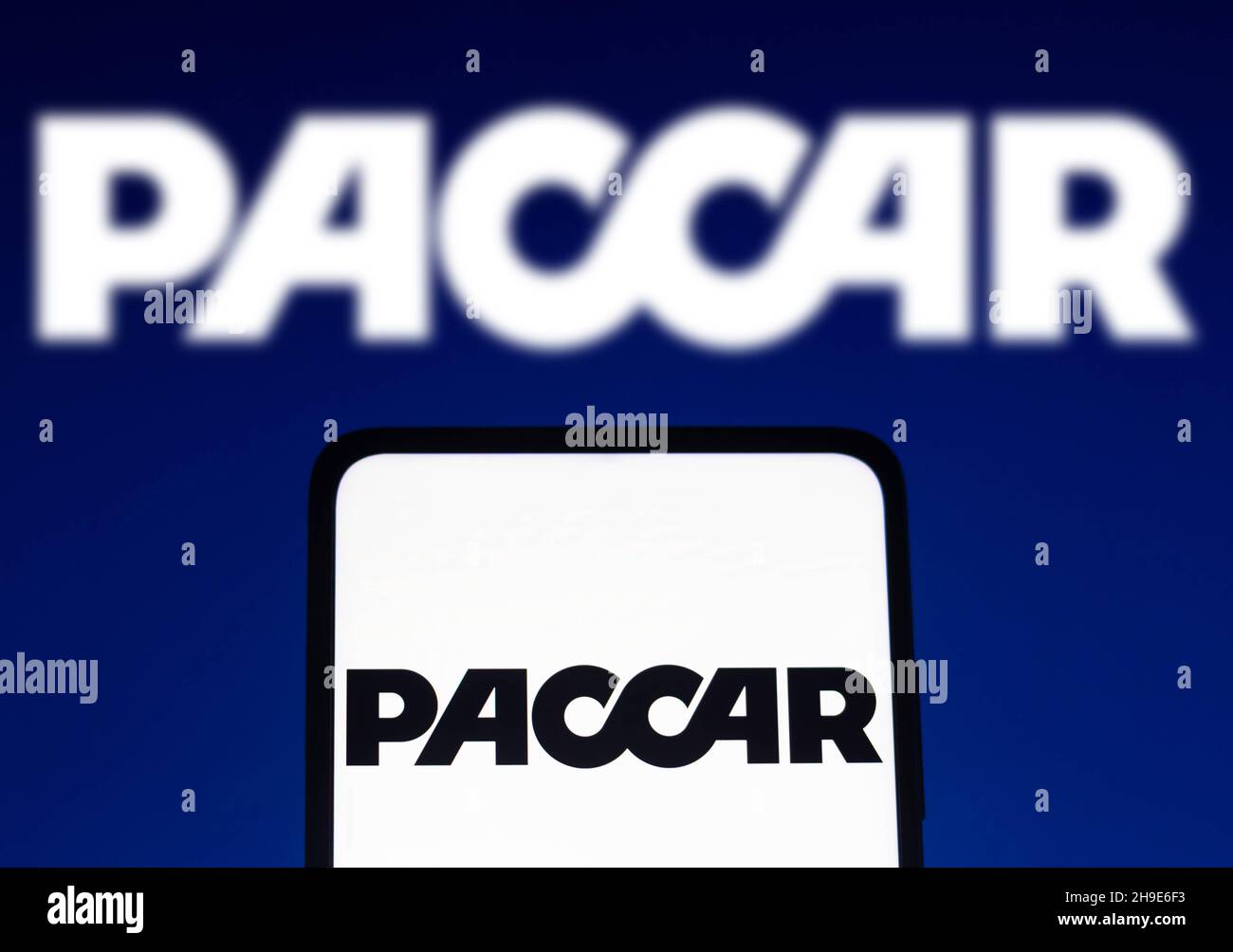 In this photo illustration the PACCAR logo seen displayed on a ...