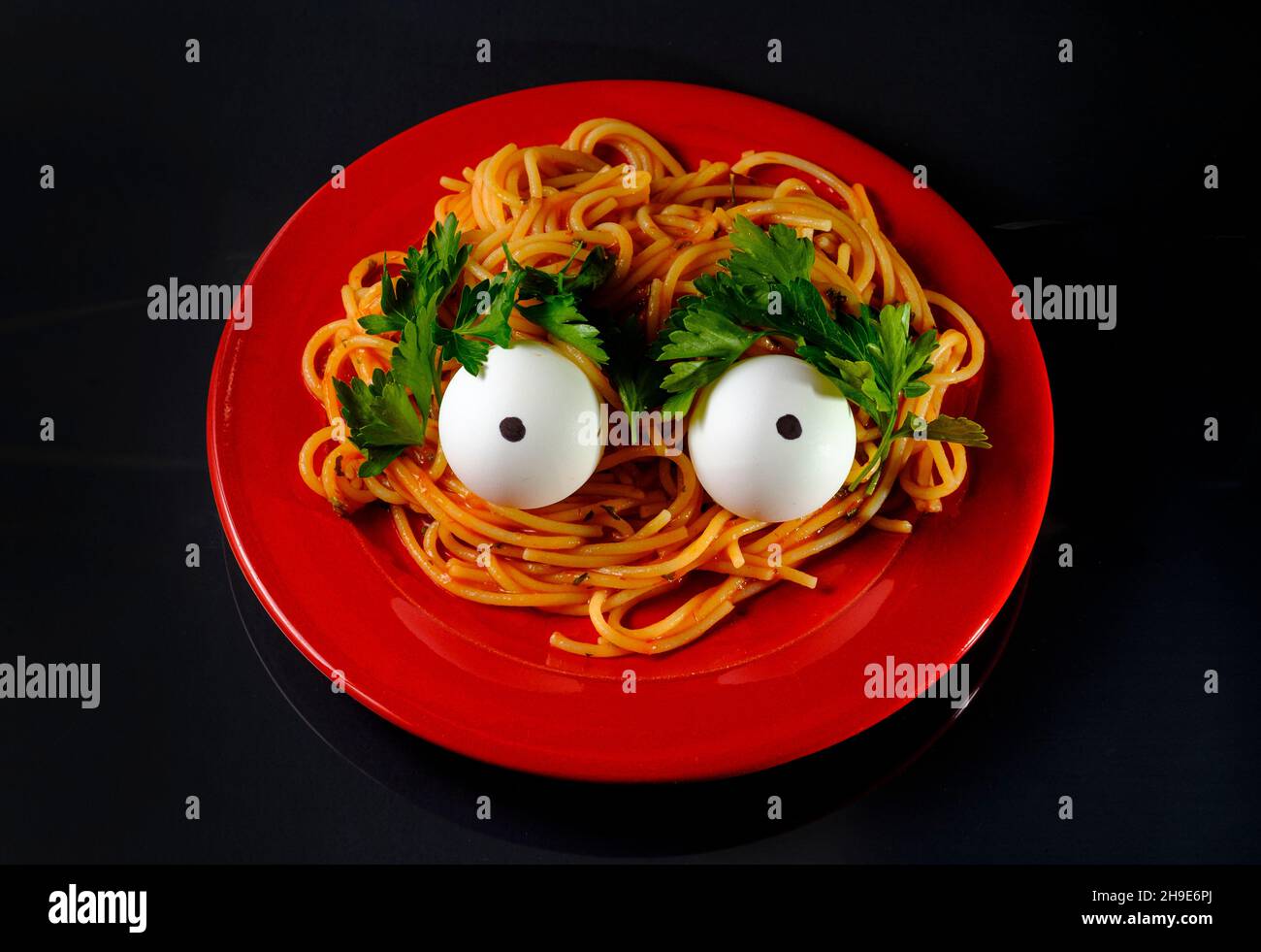 Spaghetti alien monster with eyeballs scared of being eaten Stock Photo ...