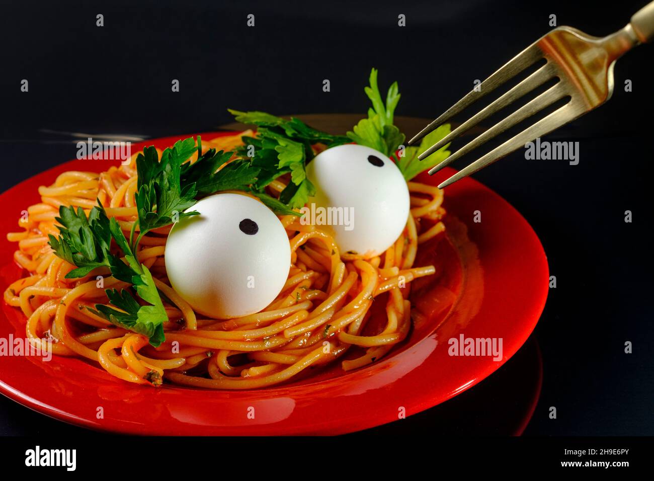 Spaghetti alien monster with eyeballs scared of being eaten Stock Photo ...
