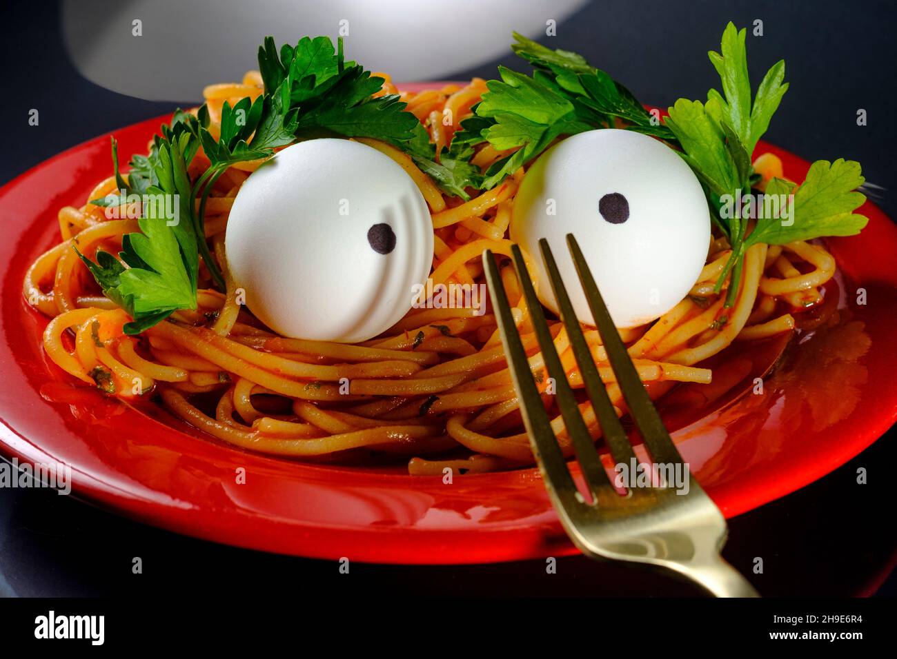 Spaghetti alien monster with eyeballs scared of being eaten Stock Photo ...