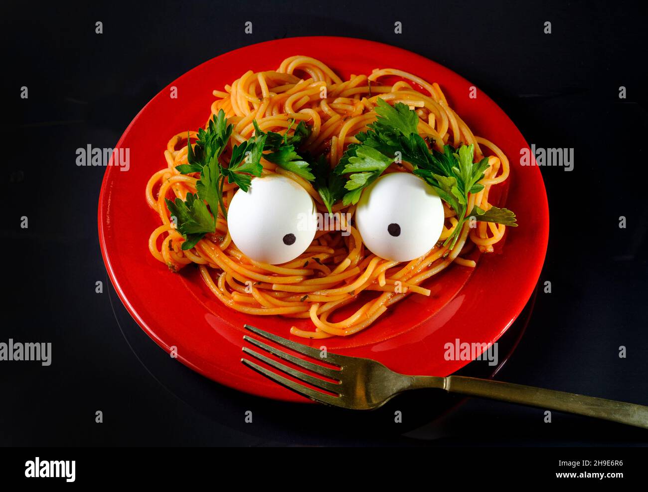 Spaghetti alien monster with eyeballs scared of being eaten Stock Photo ...