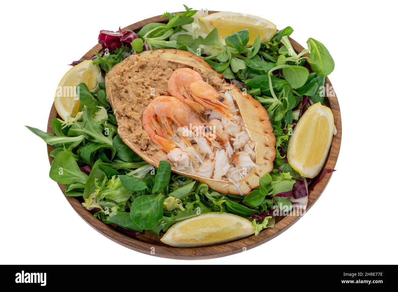 Traditional dressed crab served in its shell with salad items - white ...