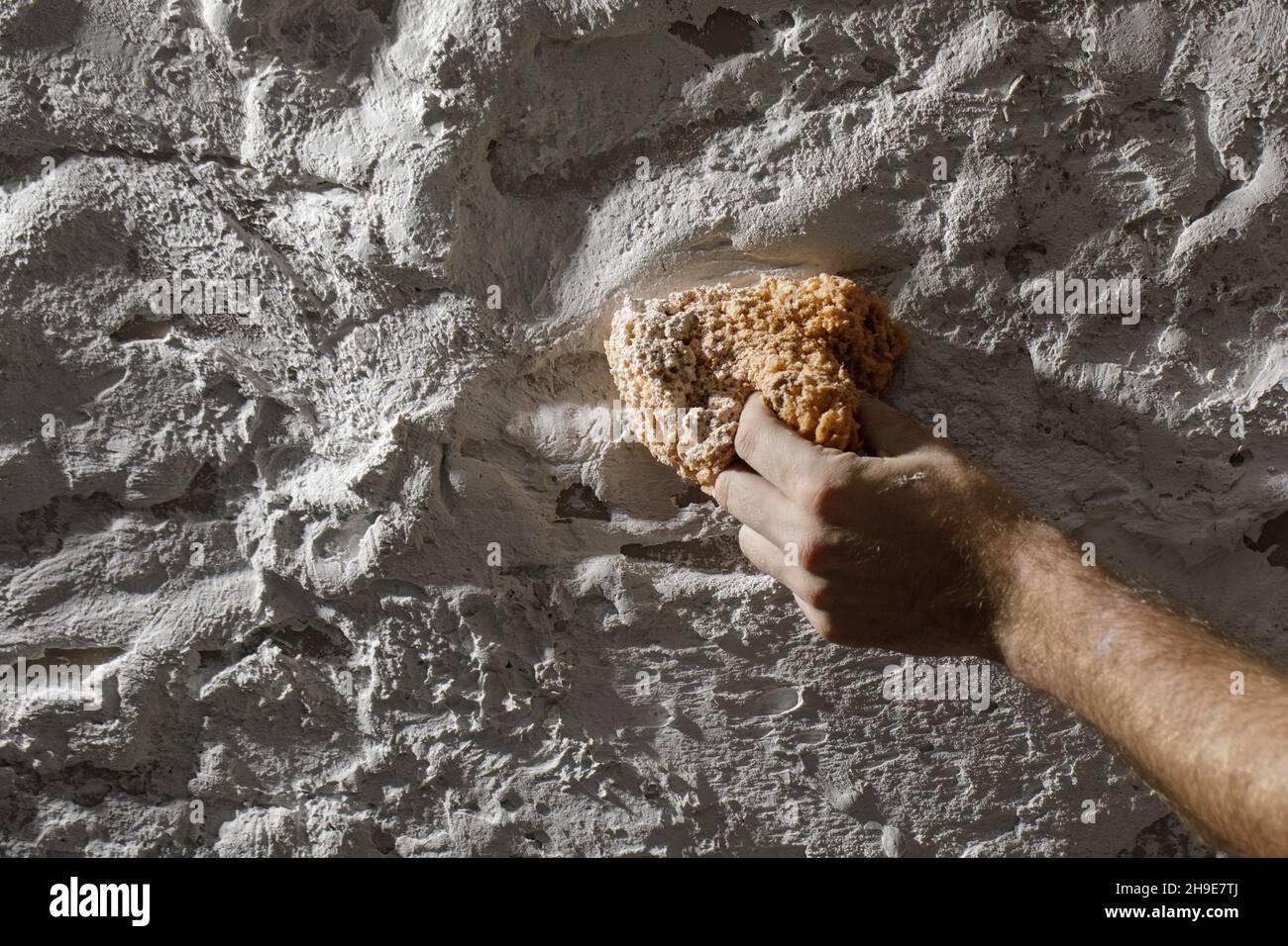 Process of creating white textured clay wall with cracks and ...