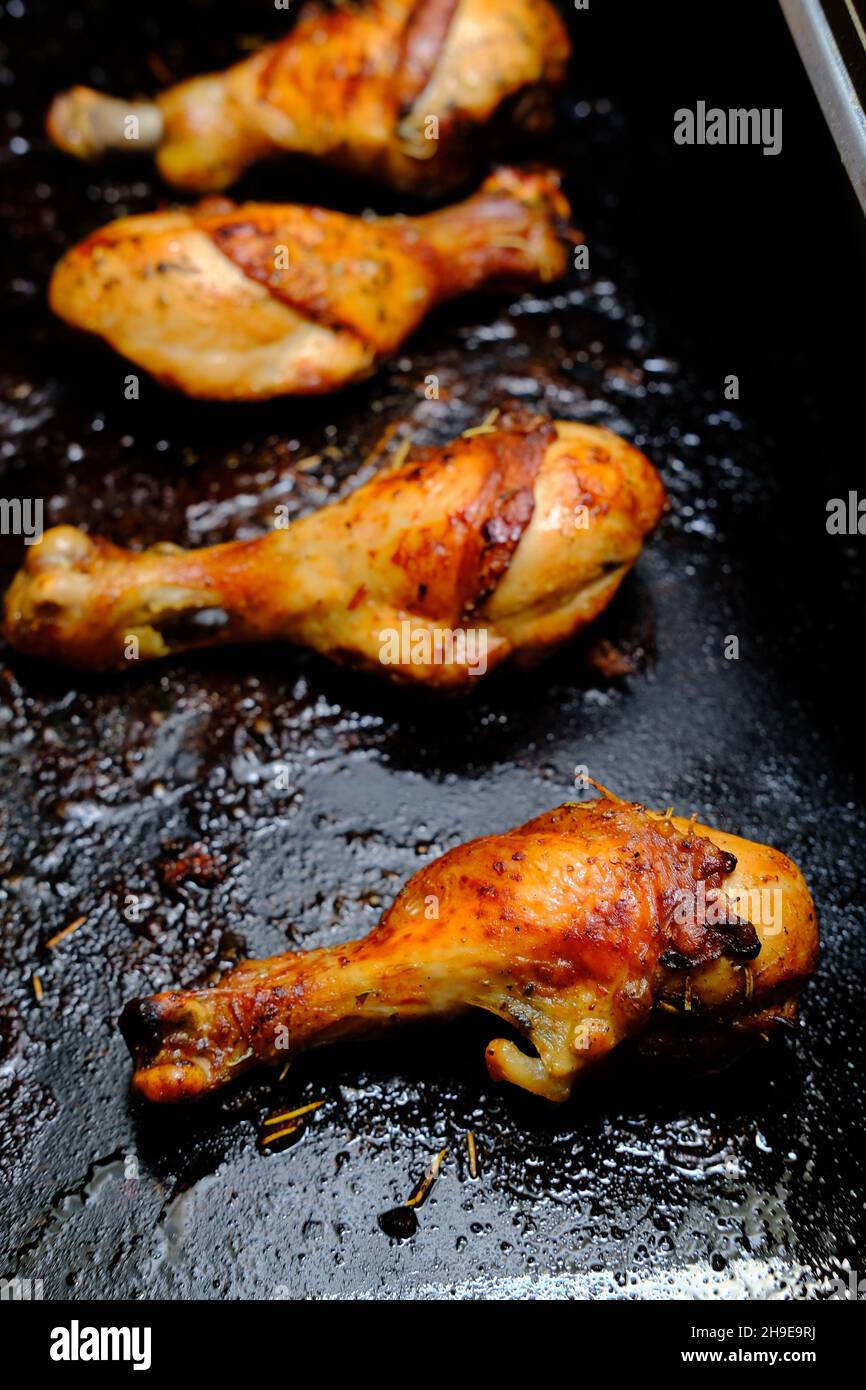 Crispy oven baked chicken legs cooling on pan Stock Photo - Alamy