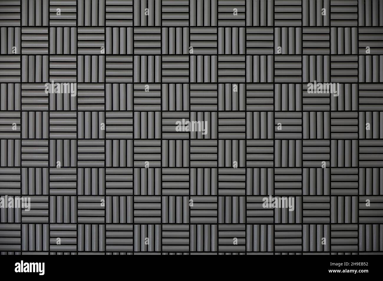 Gray tile wall with geometric pattern as background material Stock ...